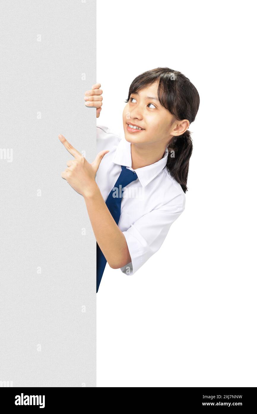 A girl pointing to a white board. She is wearing a blue tie isolated ...