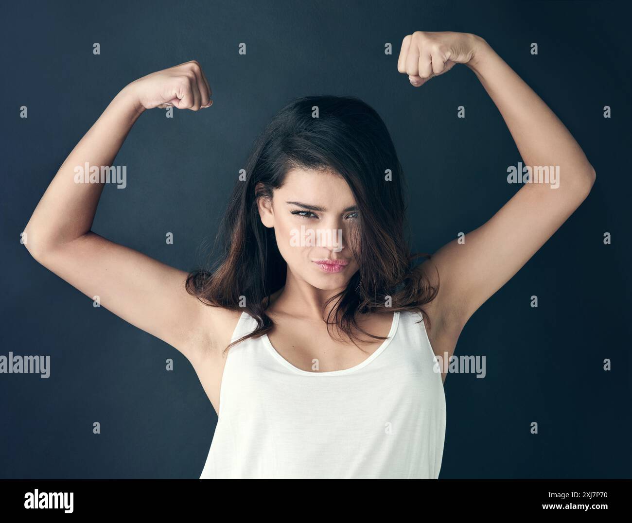 Confident, portrait and woman flex arm in studio for feminism, strength ...