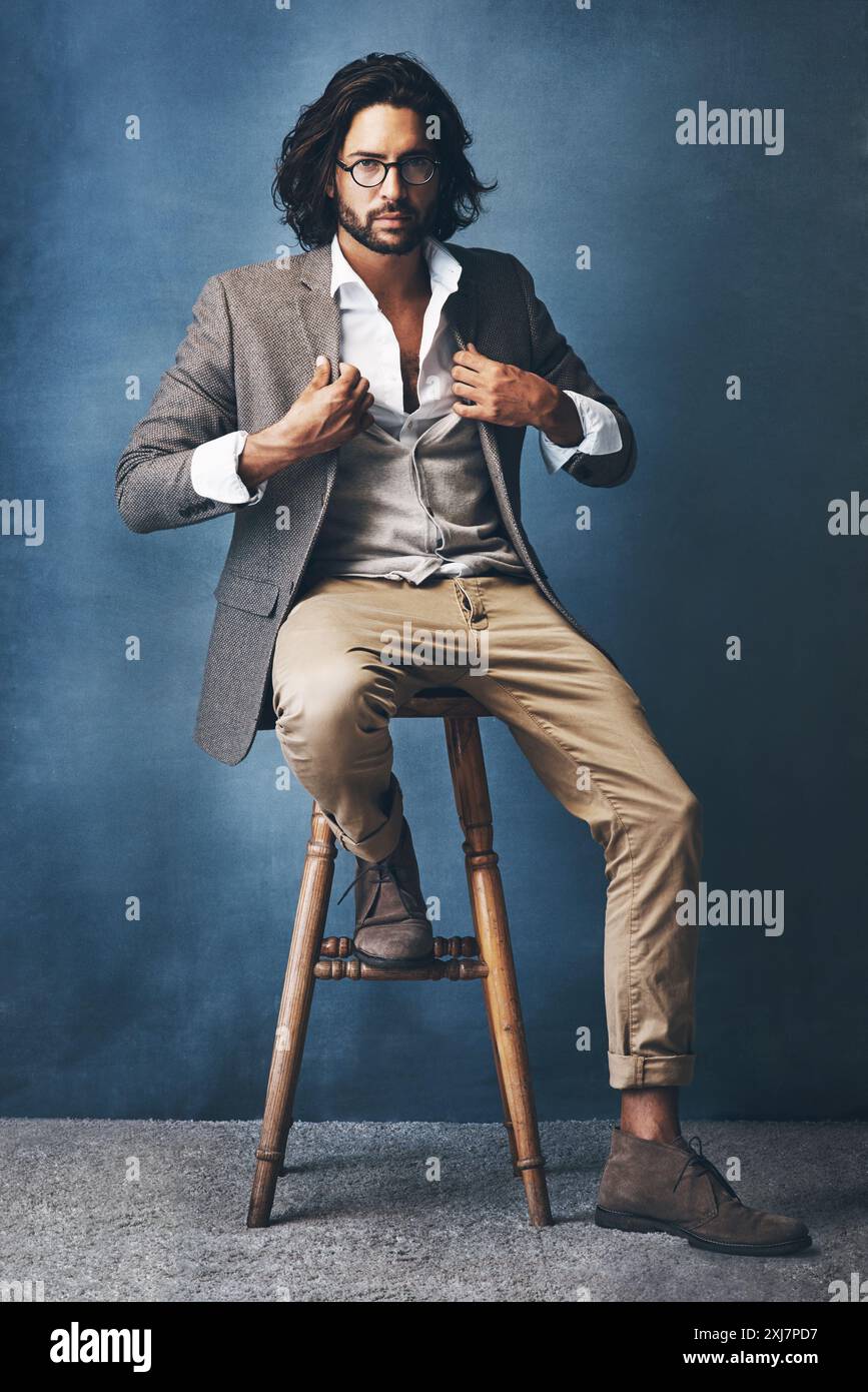 Businessman, portrait and clothes on stool in studio, professional and ...