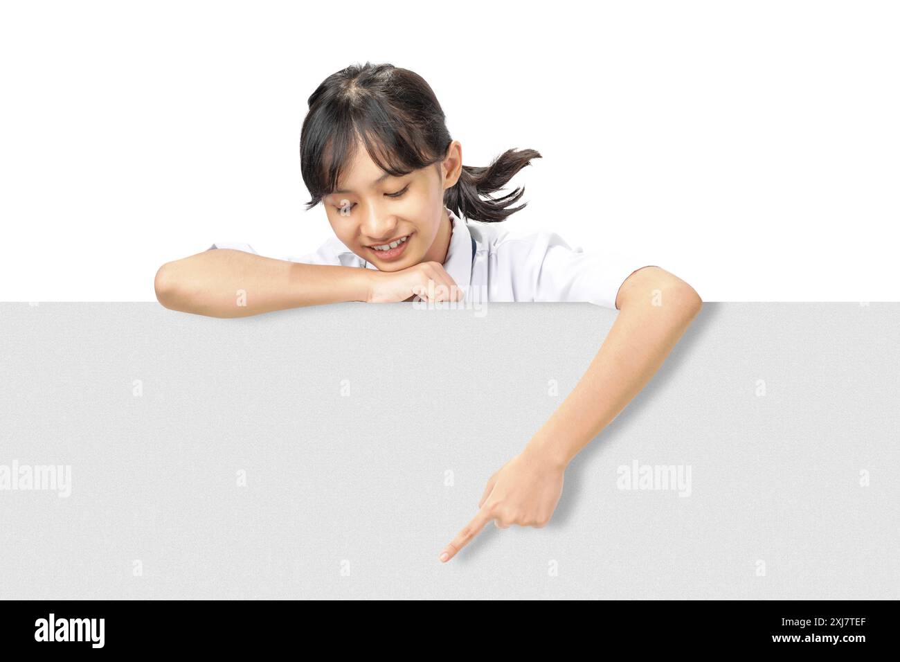 A girl pointing to a white board. She is wearing a blue tie isolated ...