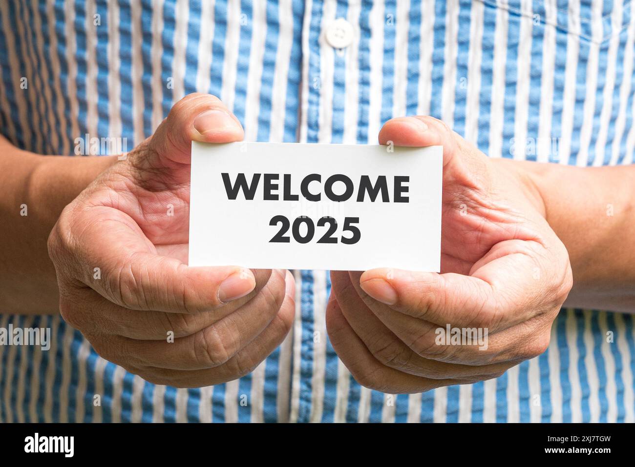 Man holding a white card with Welcome 2025. New year concept Stock ...