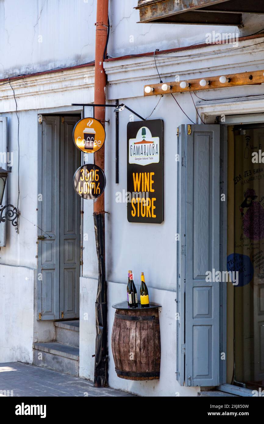 Tbilisi, Georgia - 24 JUNE, 2024: Gamarjoba Wine Store with English and Georgian signboards in ...
