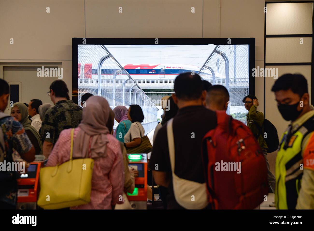Jakarta, Indonesia. 17th July, 2024. Passengers wait to check in by scanning their tickets at ...