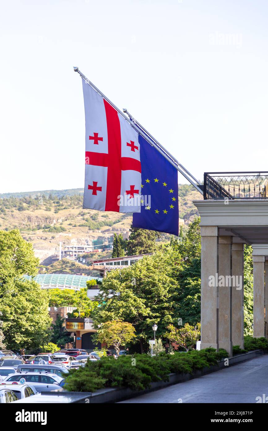 Tbilisi, Georgia - 24 JUNE, 2024: European Union and Georgian flags hanging on a balcony in ...