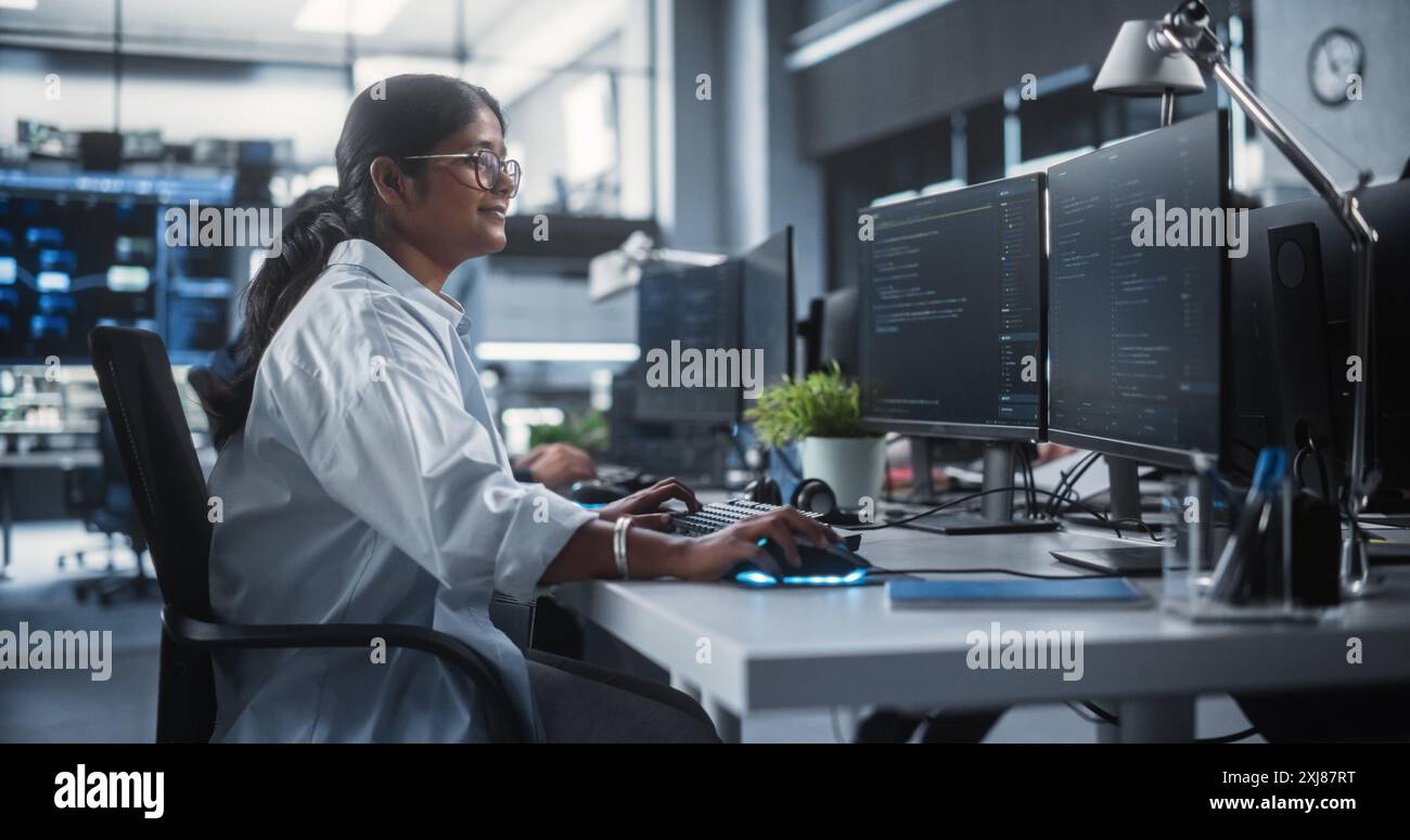 Young Female Artificial Intelligence Engineer Working on Computer in a ...