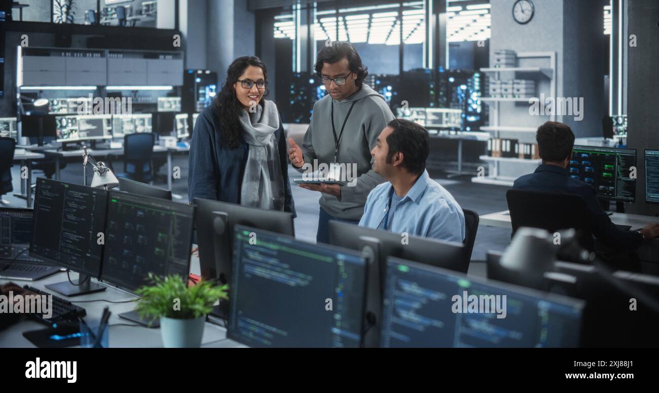 Group of Three Young Indian Software Engineers Use Computer to Discuss ...
