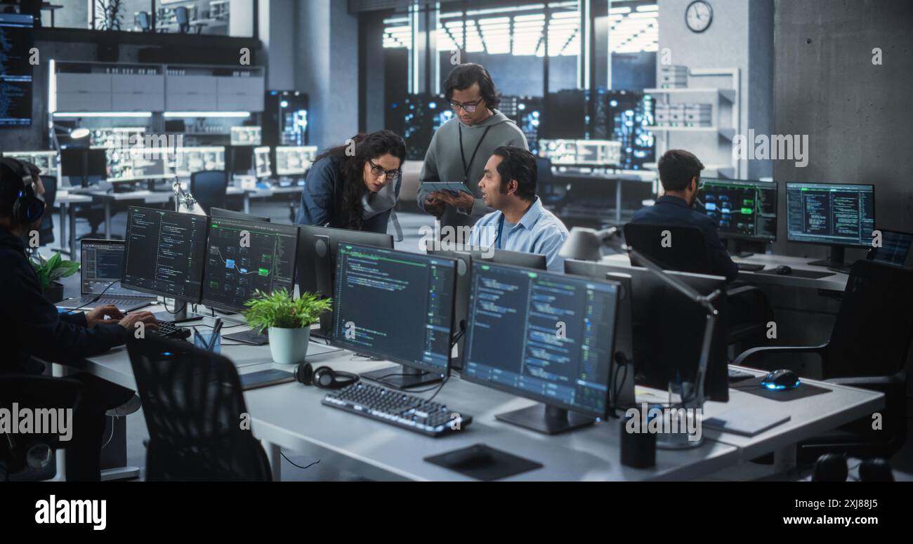 Group of Three Young Indian Software Engineers Use Computer to Discuss ...