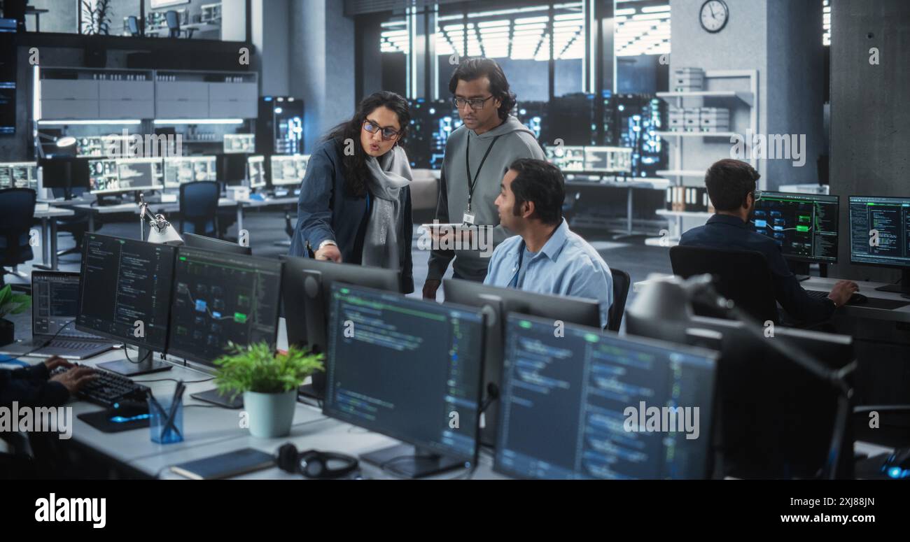 Team of Three Young Indian Software Engineers Use Computer to Discuss a ...