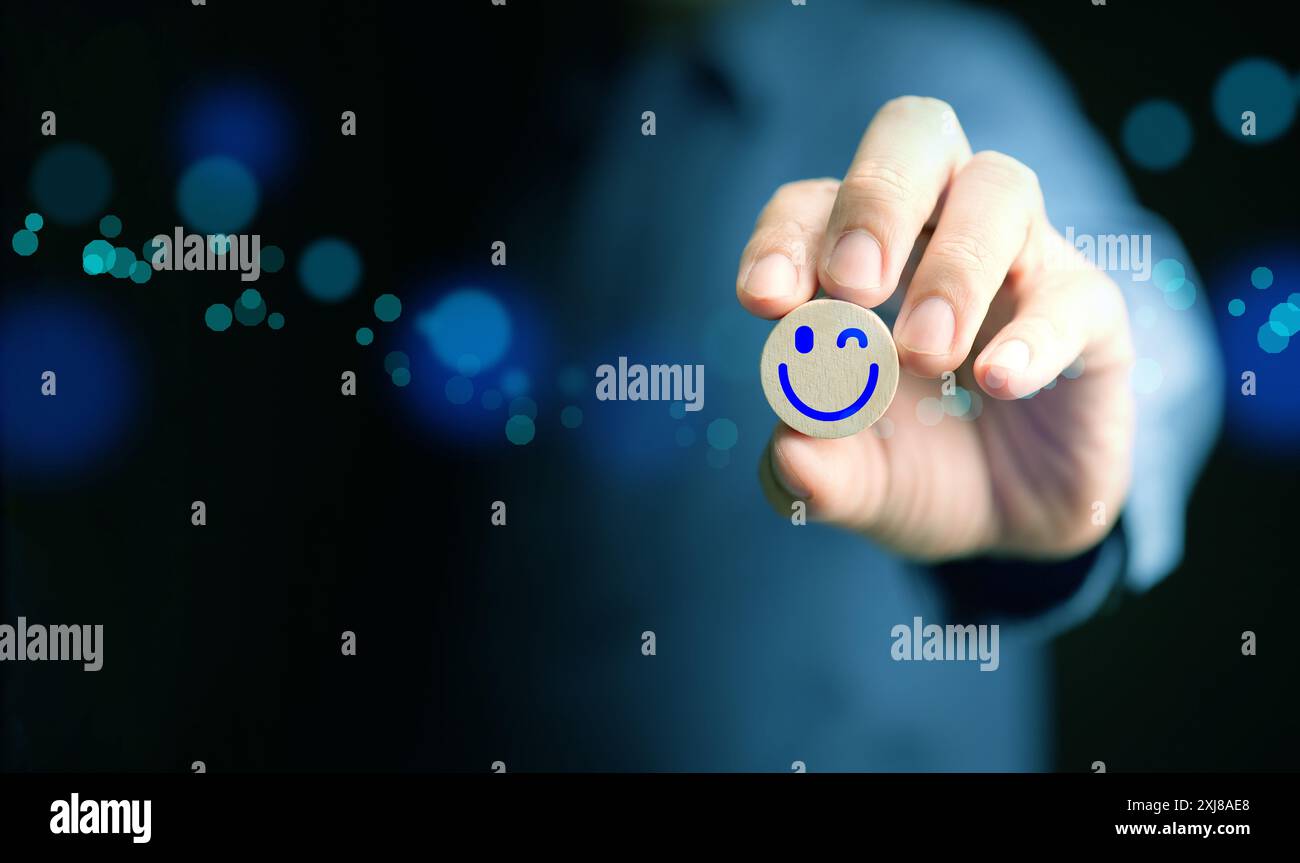 Hand holding smiley face emoticon hi-res stock photography and images ...