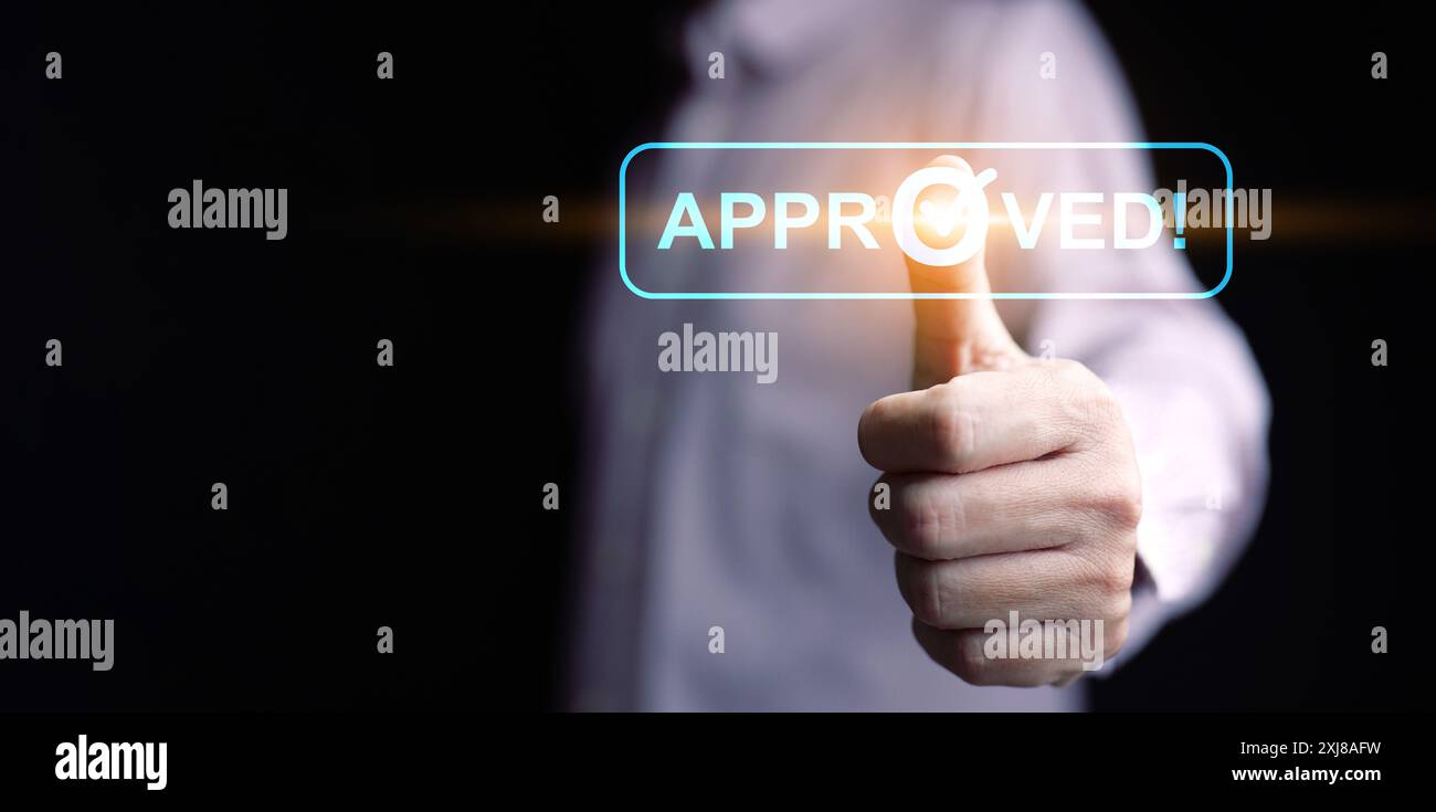Approve concept. A man gives a thumbs up with a virtual approved sign ...