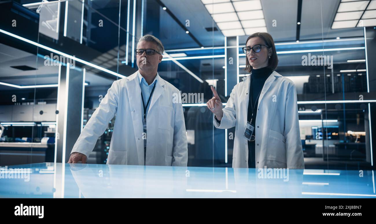 Caucasian Male And Female Scientist Standing In the High Tech ...