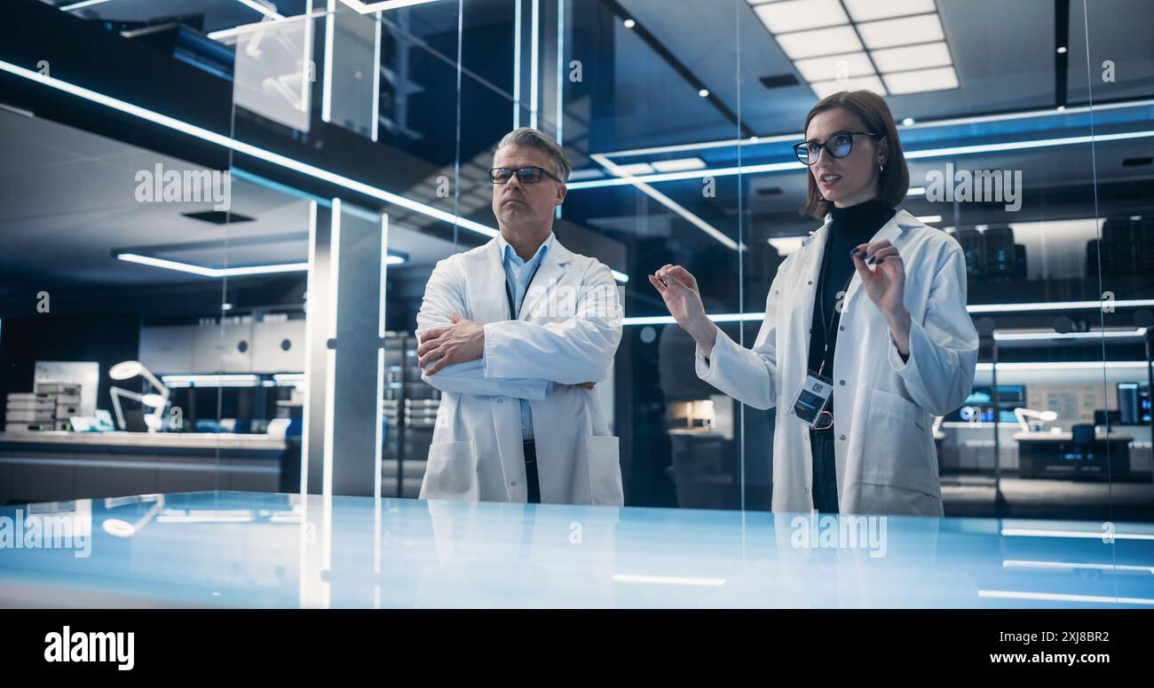 Caucasian Male And Female Scientists Standing In the High-Tech ...
