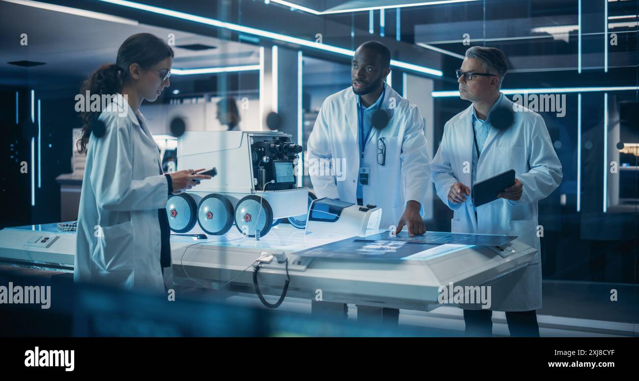 Industrial Robotics Specialists Working on a Mobile Robot, Using Tablet ...