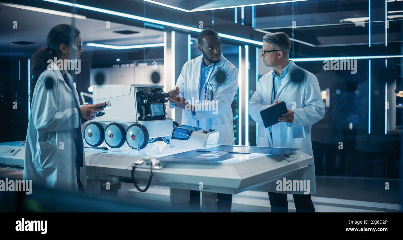 Team of Industrial Engineers Working on a Mobility Robot at a Startup Factory. Multiethnic Male ...