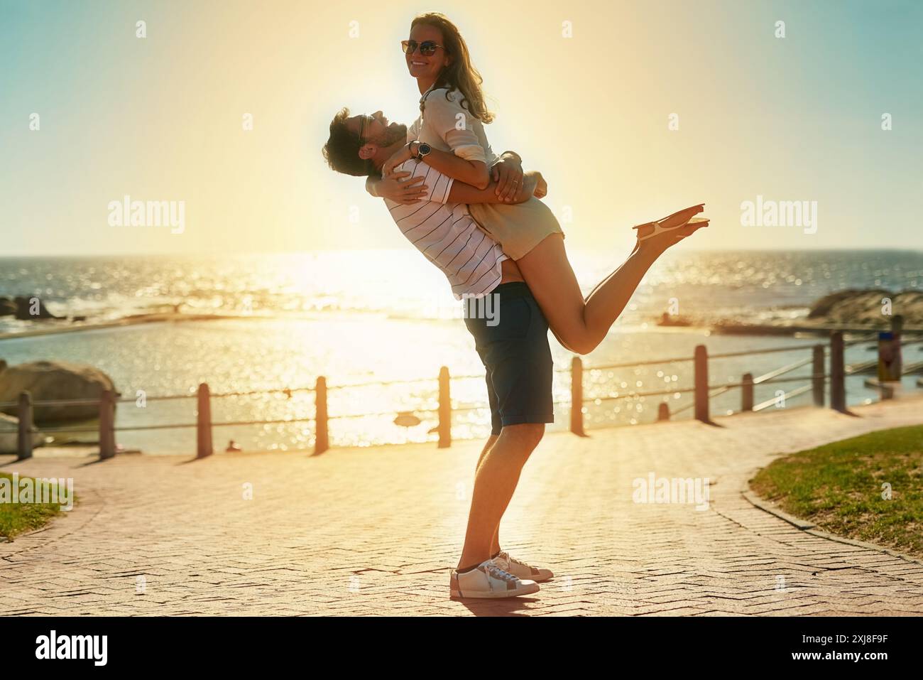 Couple, love and lifting with smile outdoor for anniversary celebration ...