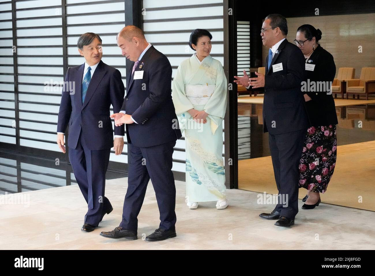 Japan's Emperor Naruhito, left, and Empress Masako, center, see off the ...