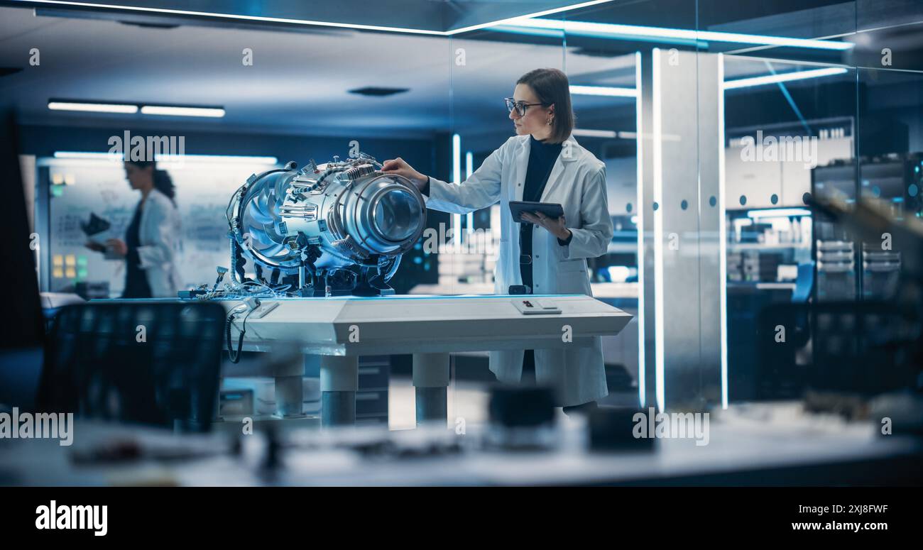Industrial Engineer Working on a Futuristic Jet Engine, Standing with ...