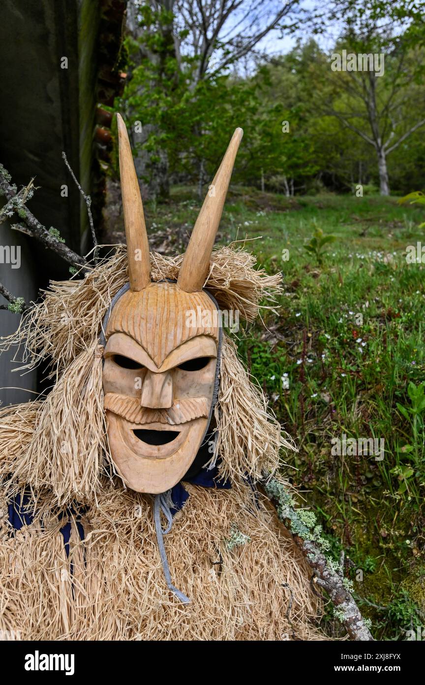 A traditional mask from Lazarim, Portugal, intricately carved from wood ...