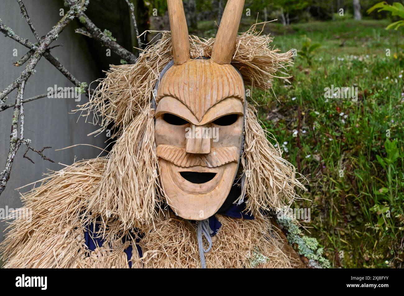 A traditional mask from Lazarim, Portugal, intricately carved from wood ...