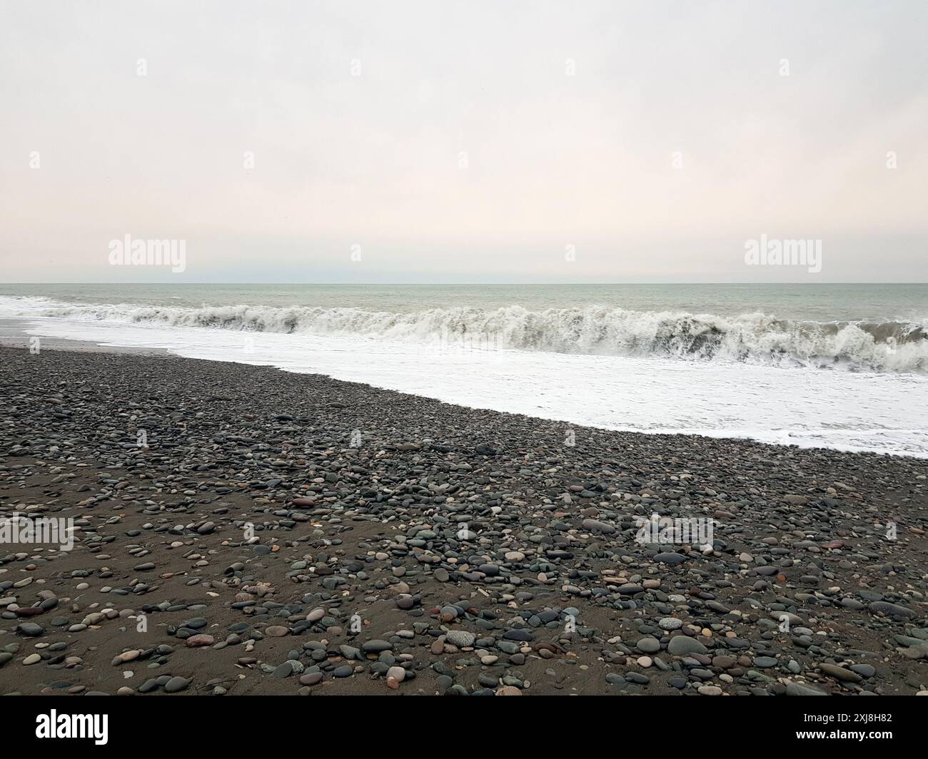 Dramatic cold ocean background with sea wave and beach with black sand ...