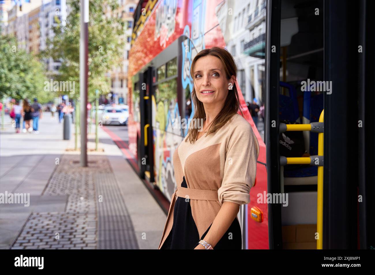 portrait of a young woman getting off the bus Stock Photo - Alamy
