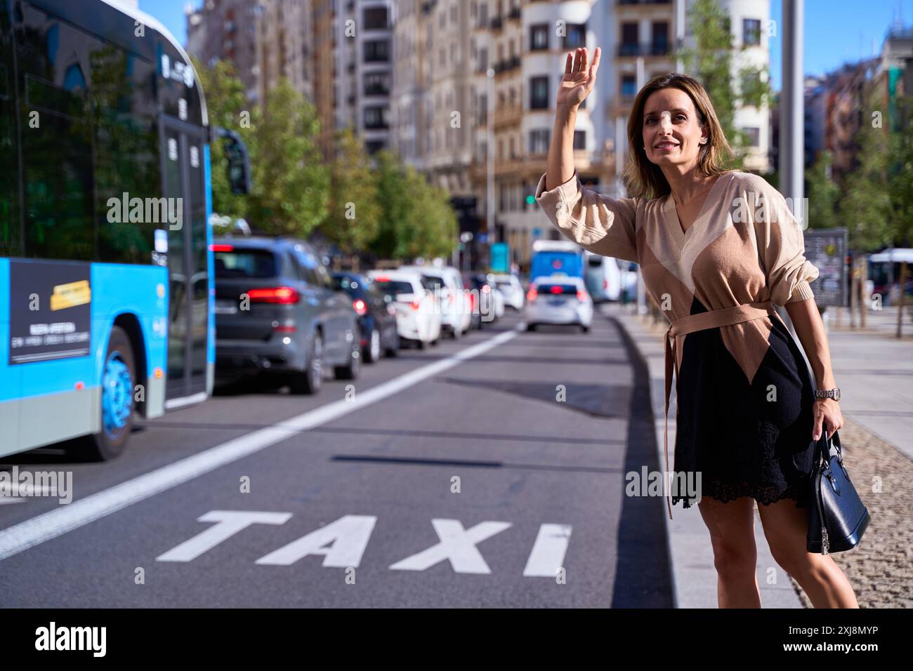 natural woman on the street hailing a cab or urban transport Stock ...