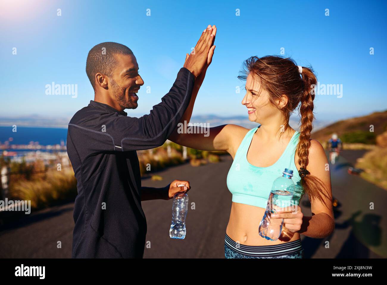 High five, man and woman on mountain for exercise, teamwork and ...