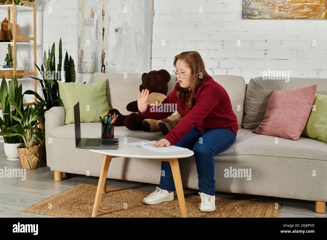 A little girl with Down syndrome studies at home on a laptop Stock ...