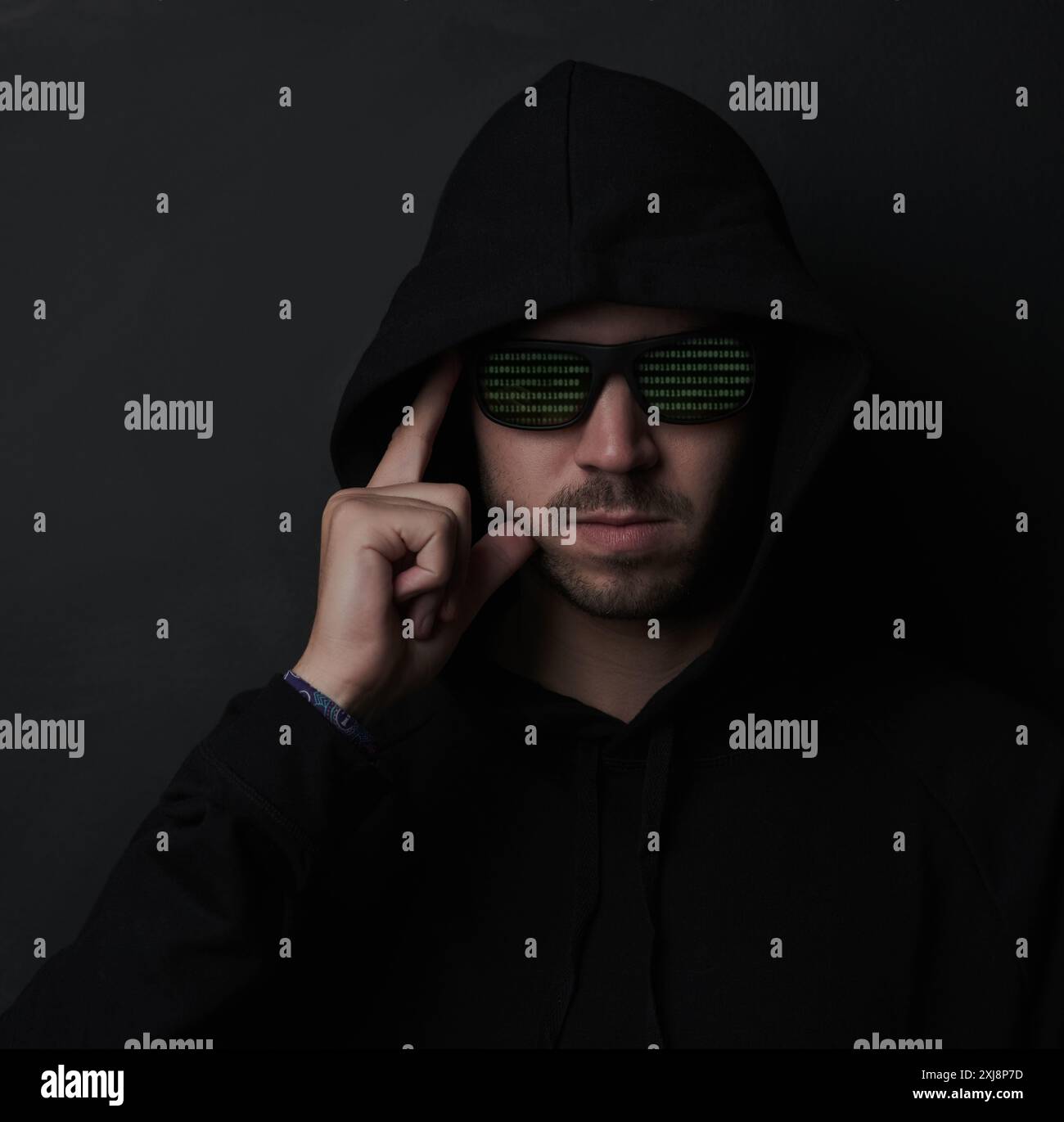 Man, hoodie and hacker in studio, glasses and undercover for stalking ...