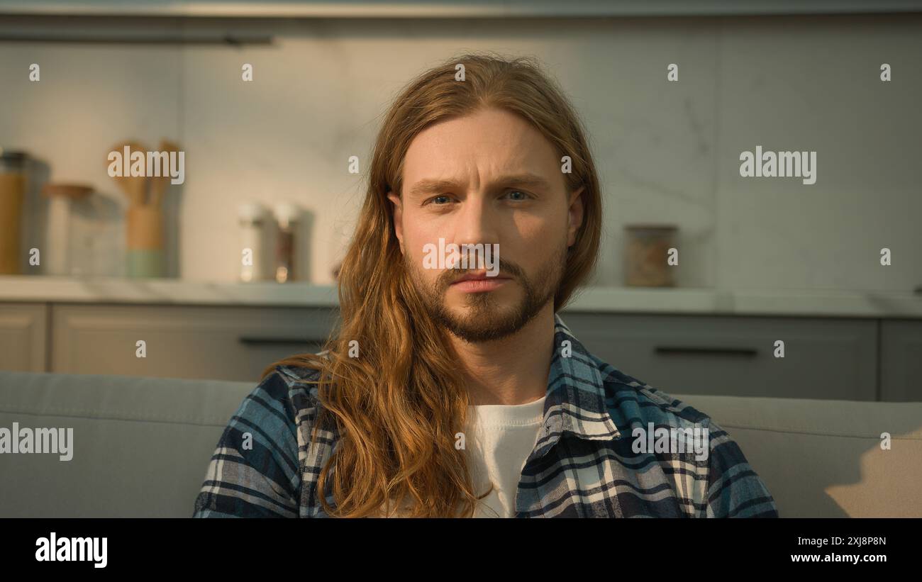 Concentrated frown serious man guy male watching TV watch television ...