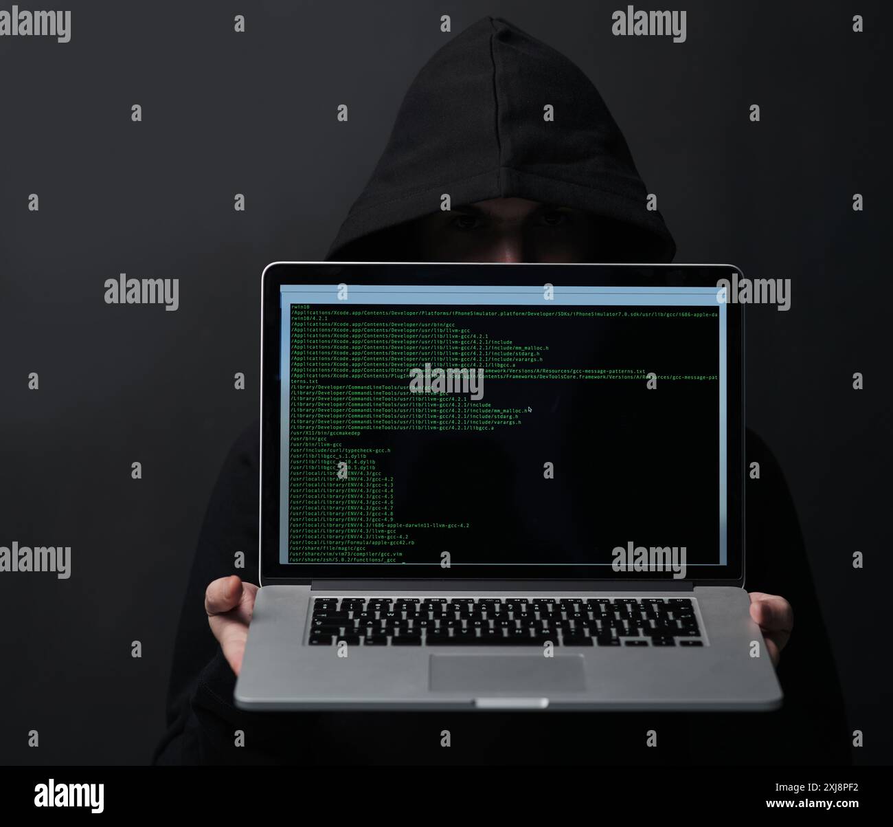 Dark, hoodie and hacker in studio, laptop and fraud of cybersecurity ...