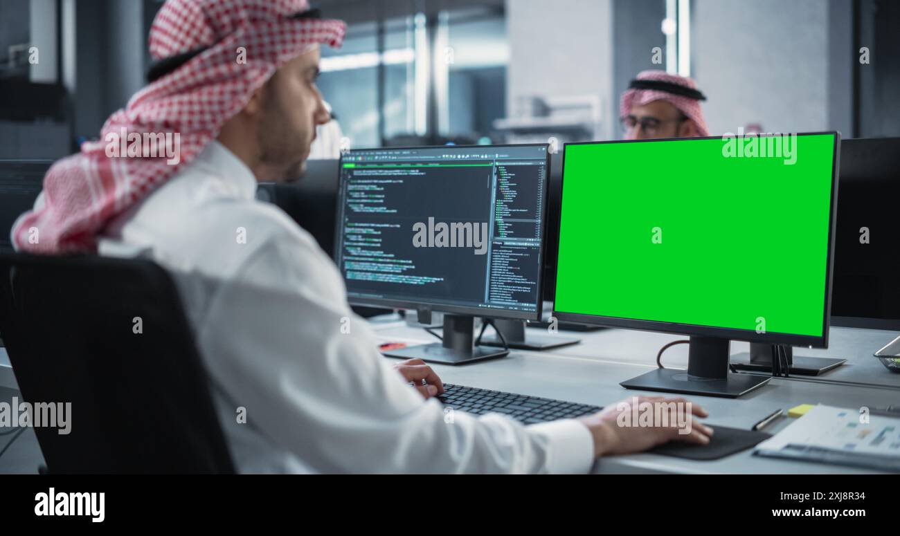 Arab Software Developer Working On Desktop Computer With Green Screen