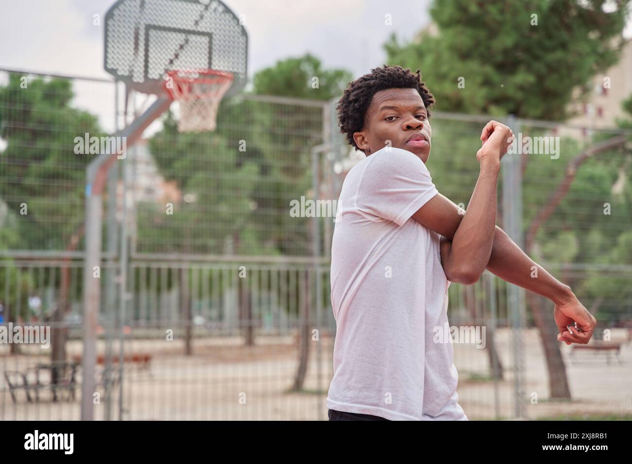 black man stretching his arms to play basketball Stock Photo - Alamy