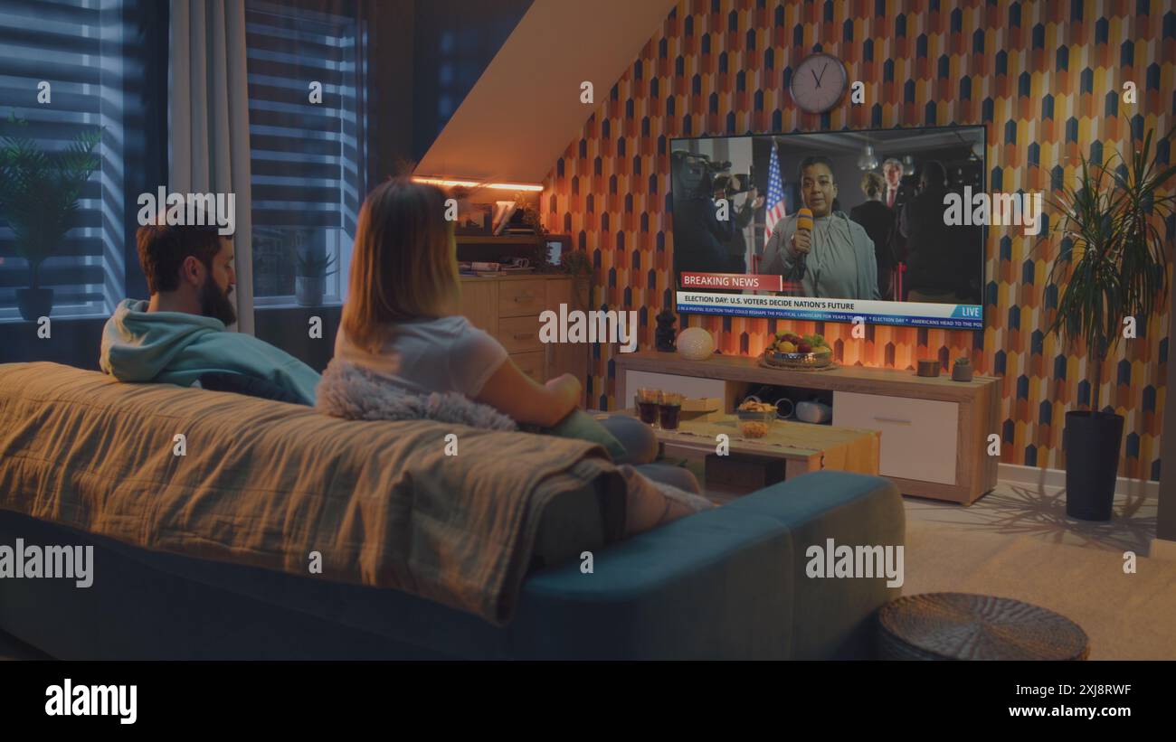 Adult couple watches news broadcast report about United States ...