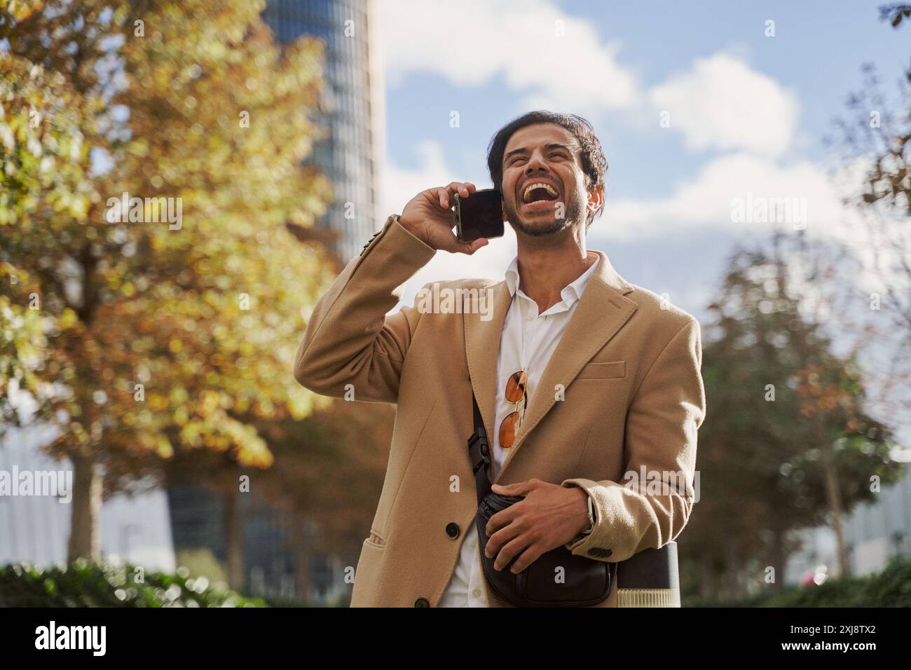 young indian man talking on his smart phone. portrait of a fashionable ...