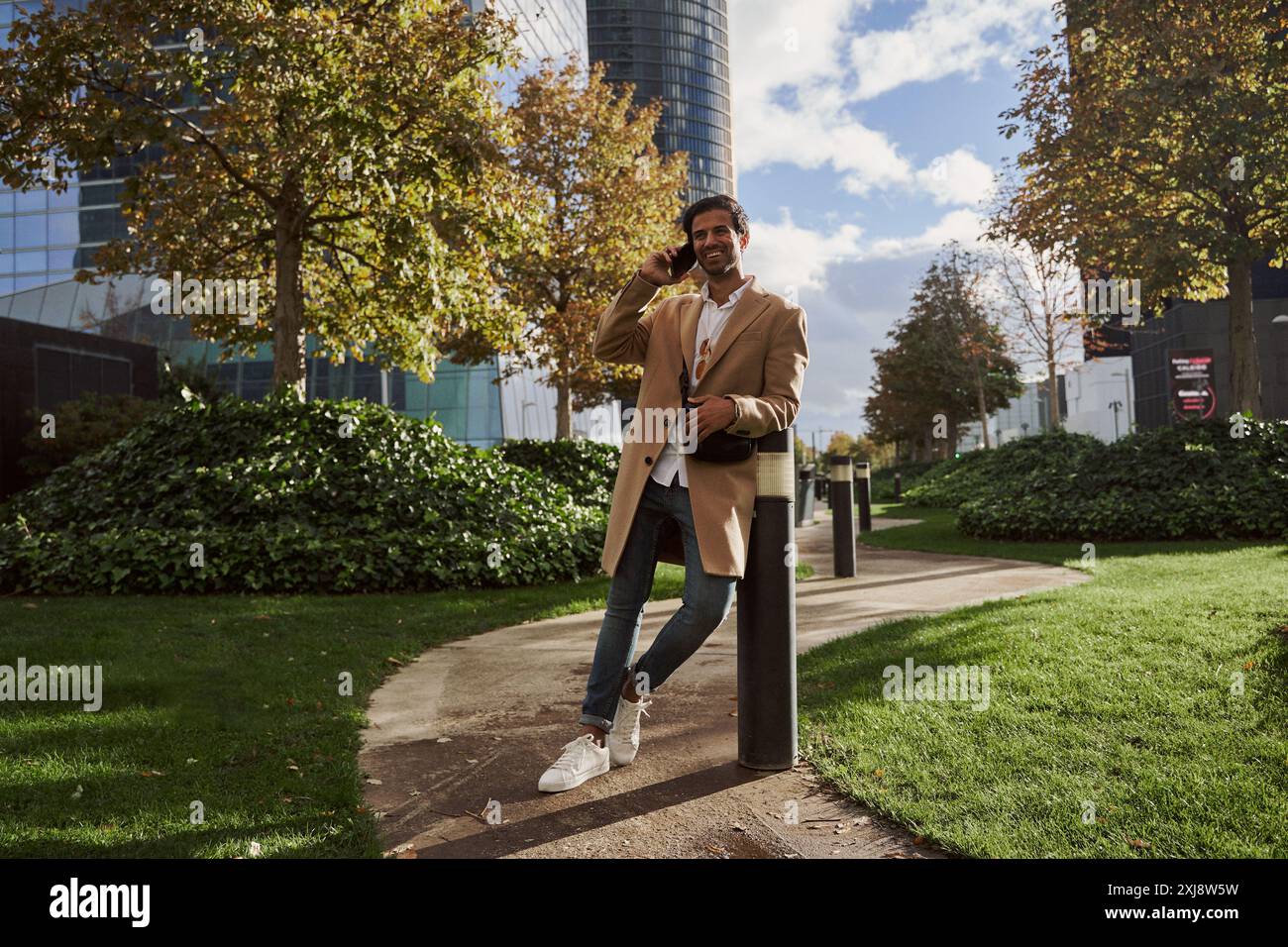 full view young indian man talking on his smart phone. portrait of a ...