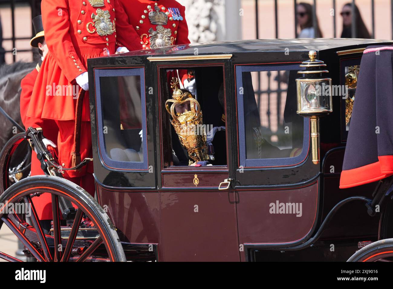 The ceremonial mace is displayed from a window of a state carriage, as ...