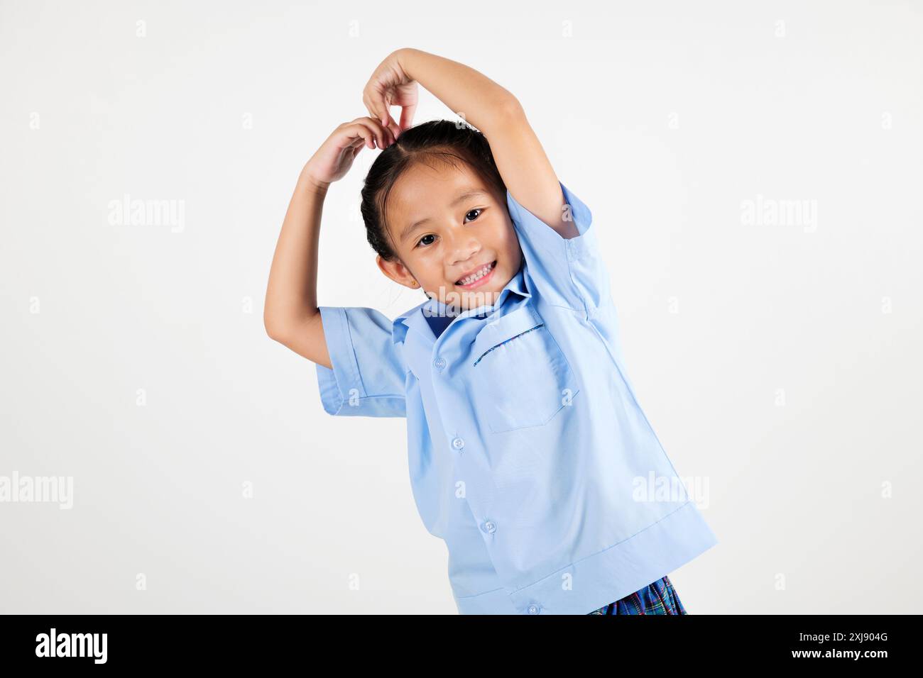 Portrait smile Asian little girl kindergarten showing heart shape sign ...