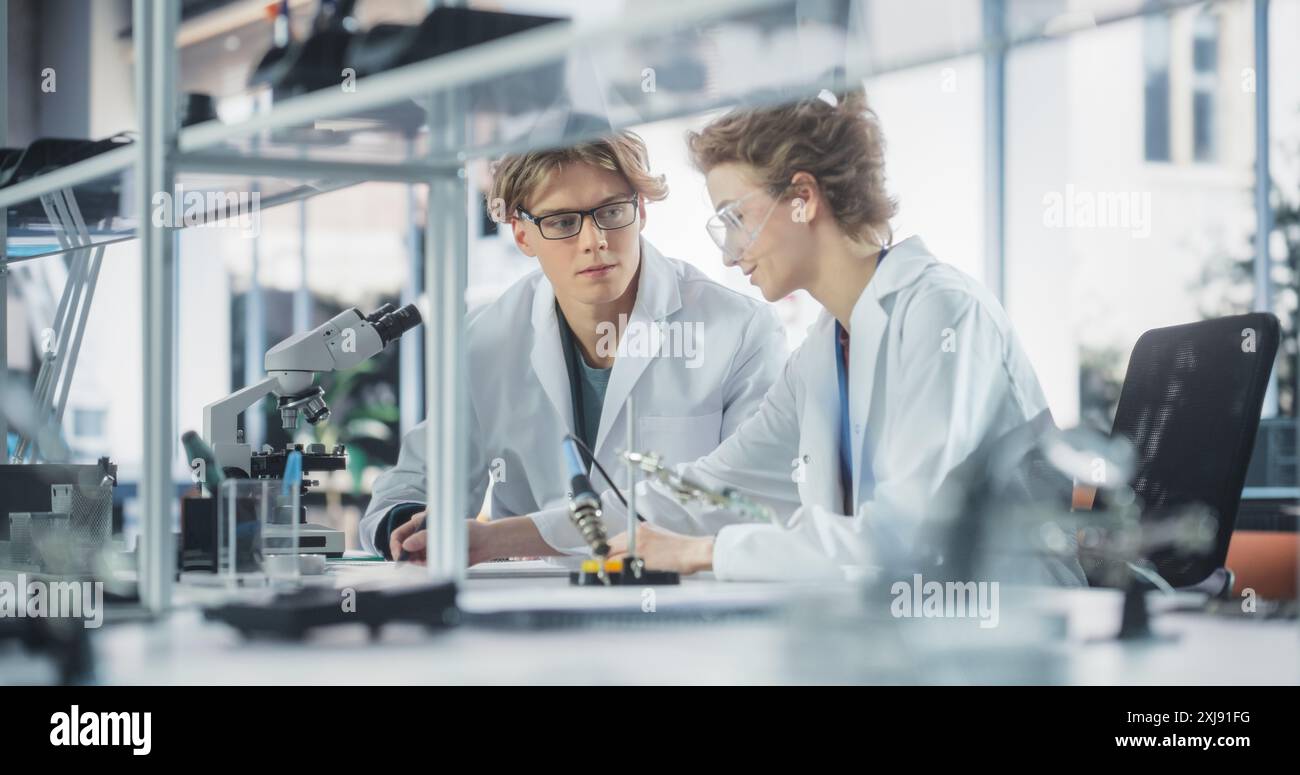 Young Female and Male Students Working Together in Laboratory Classroom ...