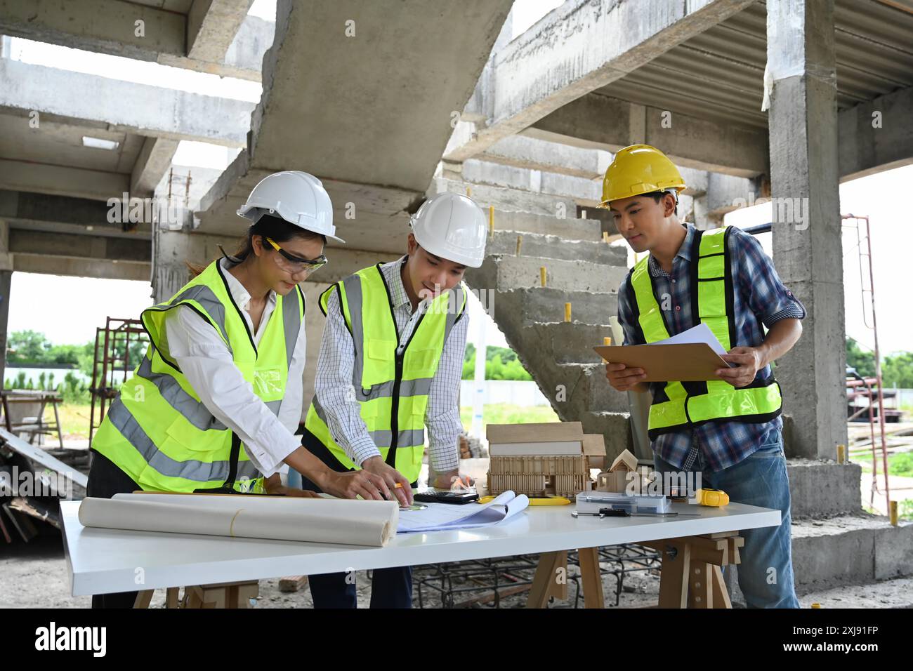 Group of construction professionals wearing safety helmets in a ...