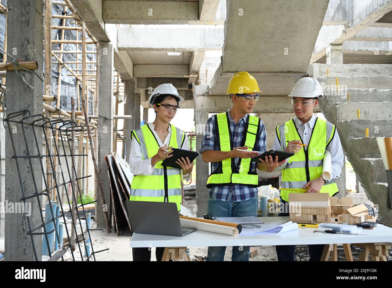 Group of construction professionals wearing safety helmets in a ...