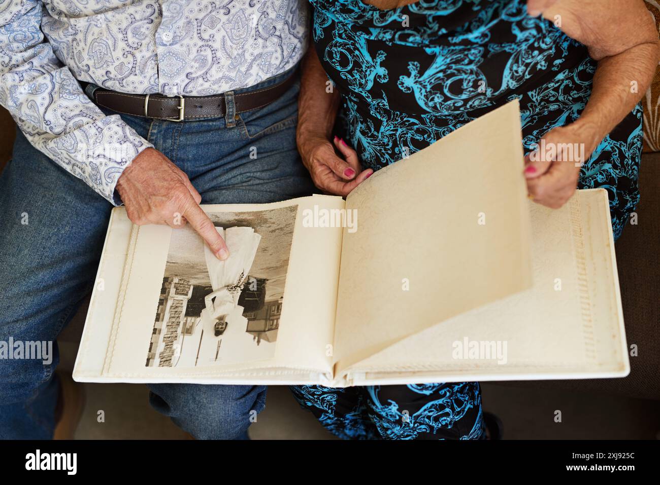 Senior couple, photo album and memories in home, living room and ...