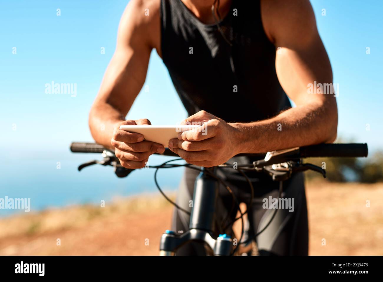Mountain bike, hands or cyclist outdoor with smartphone for fitness ...