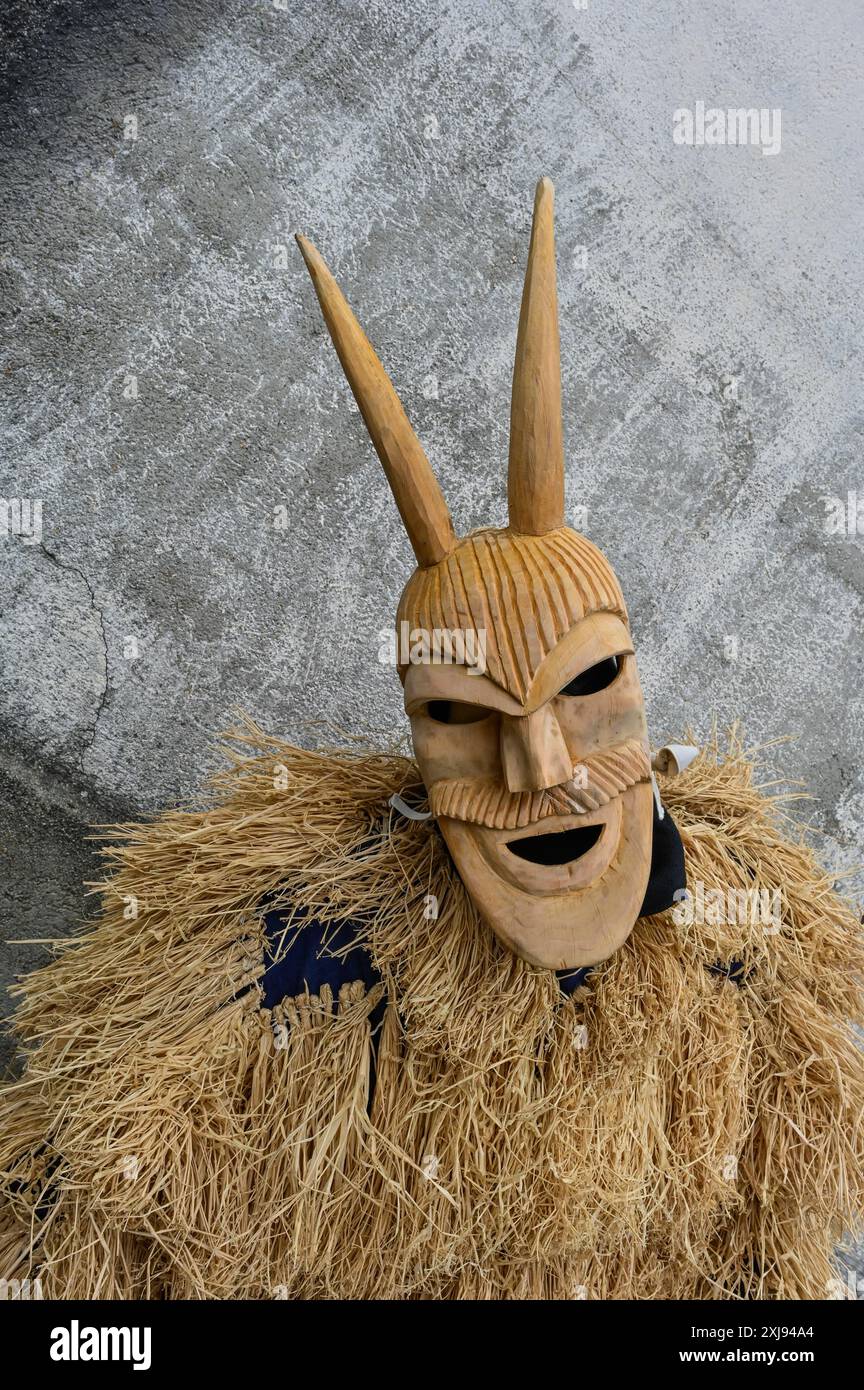 A traditional mask from Lazarim, Portugal, intricately carved from wood ...