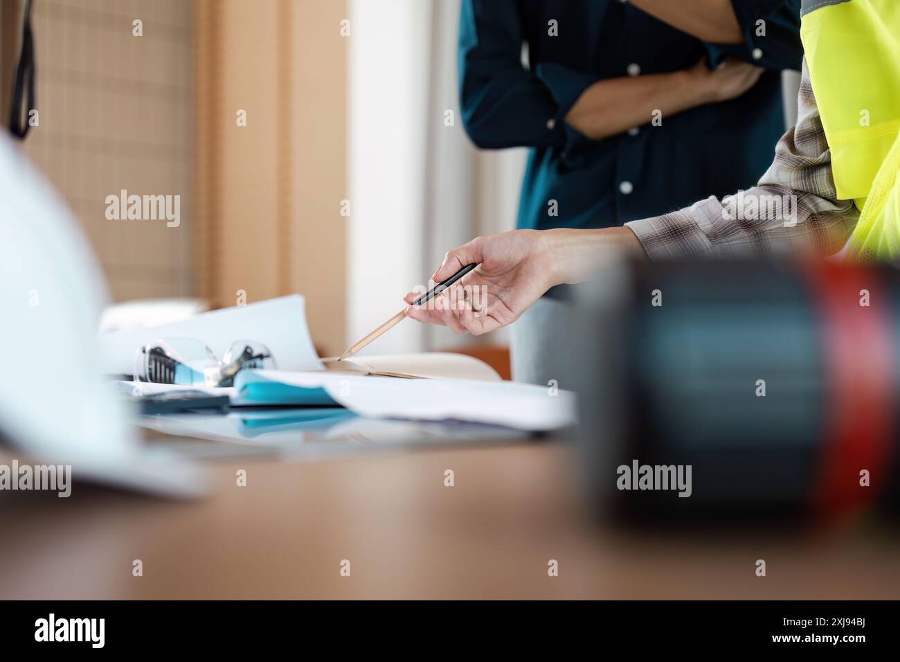 Engineer Discussing Project Plans with Colleague in Modern Office ...