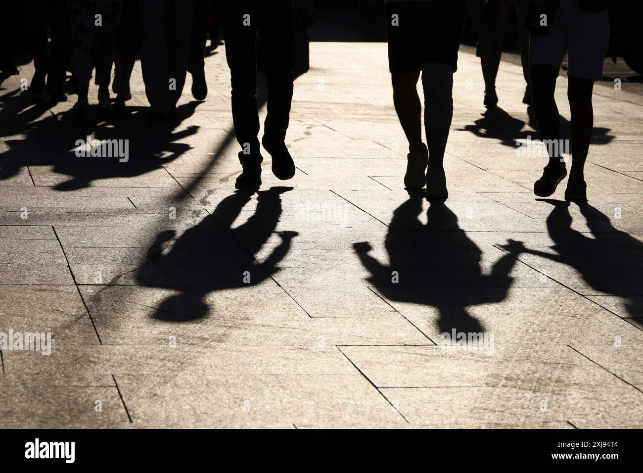 Black silhouettes and shadows of people on the street. Crowd walking ...