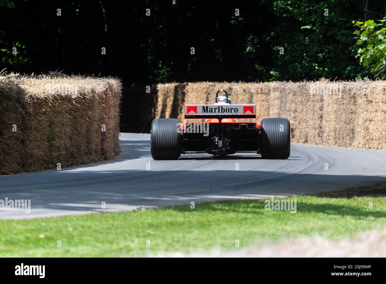 1982 McLaren-Cosworth MP4/1B race car driving up the hill climb track ...