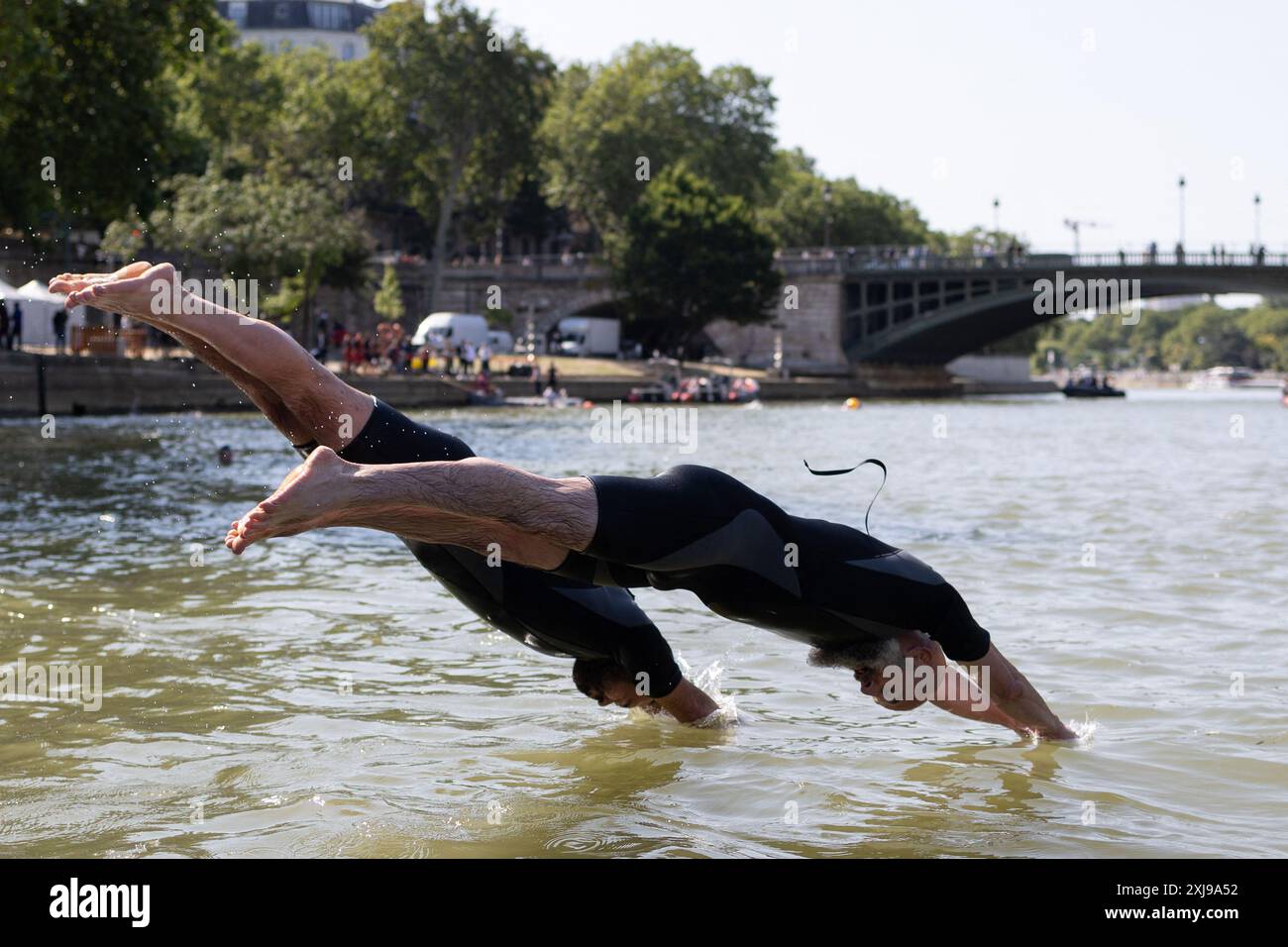 People dive in the Seine, in Paris on July 17, 2024, after the mayor of ...