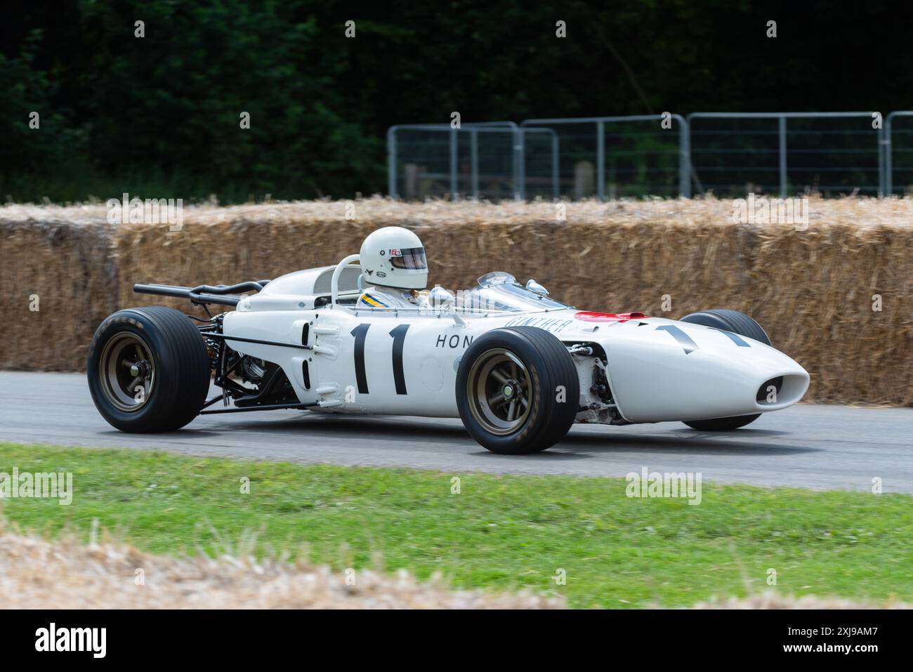 1965 Honda RA272 Formula 1 race car driving up the hill climb track at ...