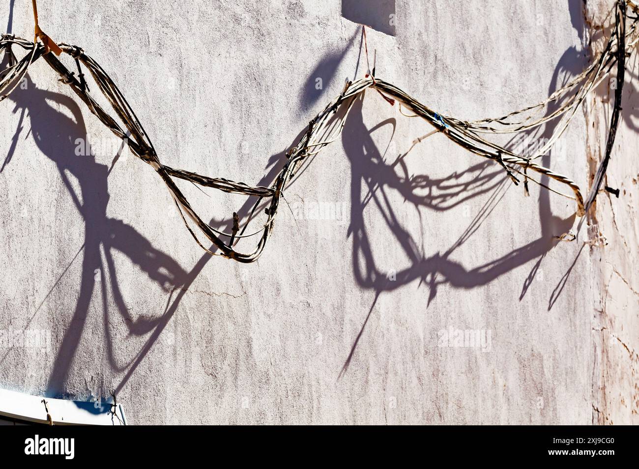 Electrical wiring on a white façade in Alhambra Stock Photo - Alamy